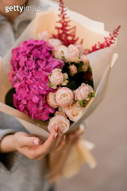 Close-up of lush bouquet of of pink roses and hydrangea and heather in ...