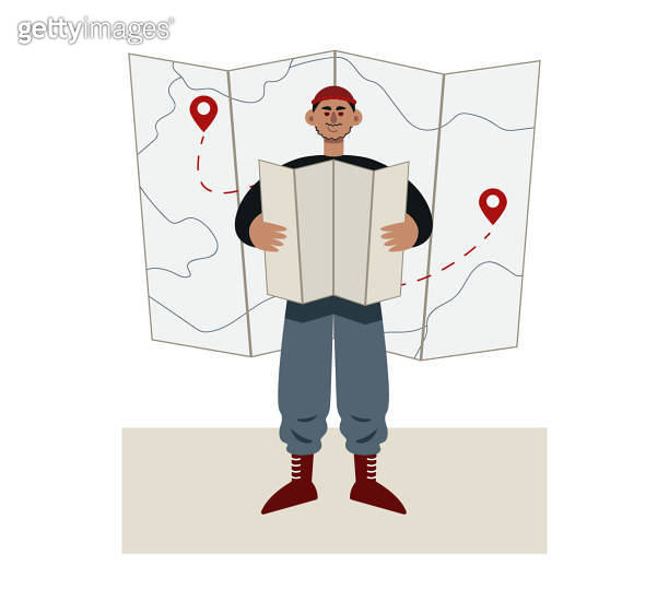 Man looks at map, preparing for trip. Building route through unfamiliar ...