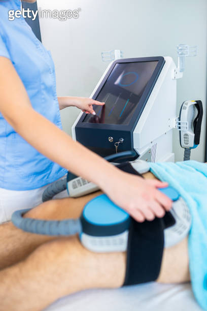 Beautician therapist applying burn fat and build muscles treatment in ...