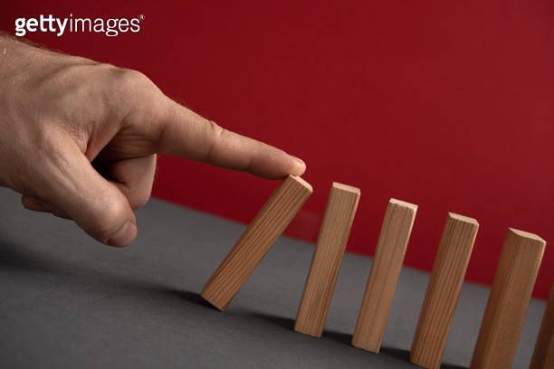 Domino has Fallen in a Row. Domino theory. Effect. Hand with Finger is ...