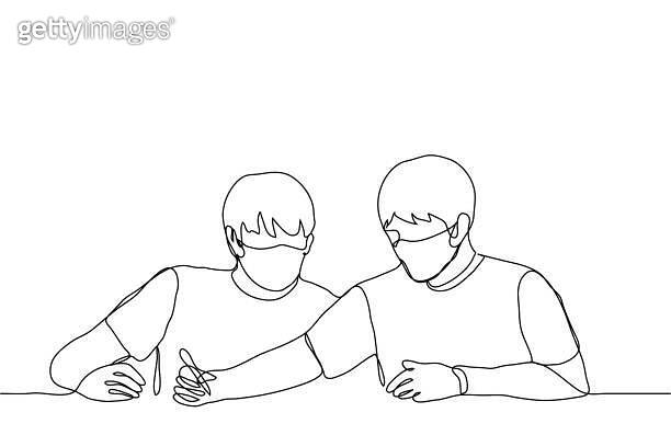 two men in masks are sitting at the table, one of whom is writing with ...