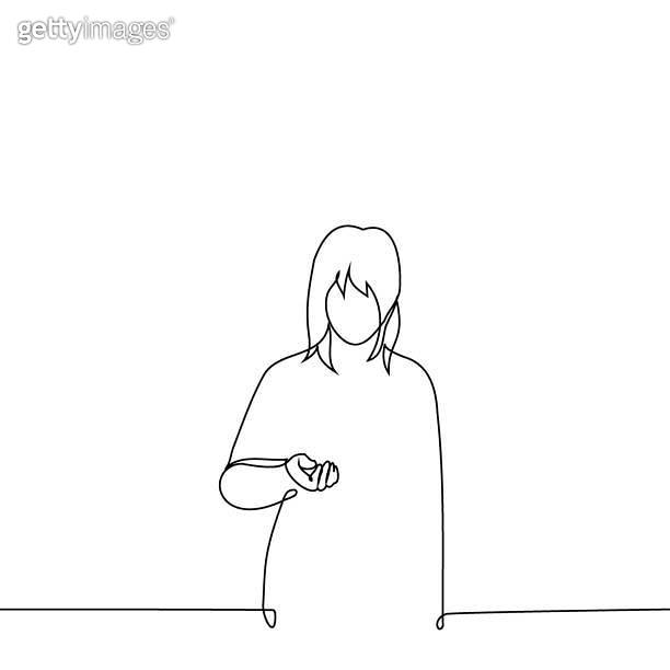 woman stands with an outstretched hand or looks at a change in his hand ...