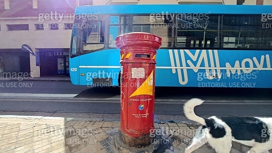 A red mailbox, and a passing dog and bus, in ARG. Cell Phone photo. Oct ...