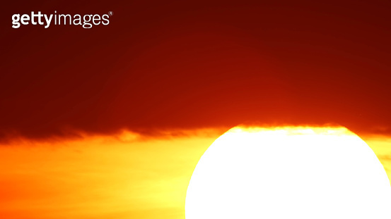 Big bright yellow hot sun disk moves down as sunset. Epic sky and sky ...
