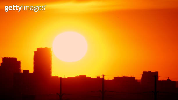 Big bright yellow hot sun disk moves down as sunset. Epic sky and sky ...
