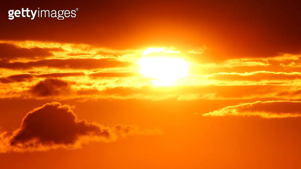 Big bright yellow hot sun disk moves down as sunset. Epic sky and sky ...