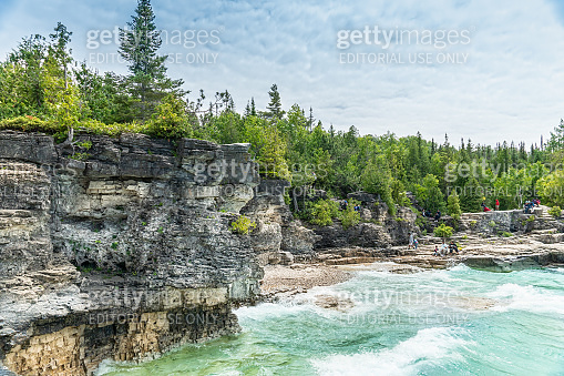 Indian Head Cove At Tobermory Turquoise Blue Water And Green Pine Forest In Ontario Summer Day