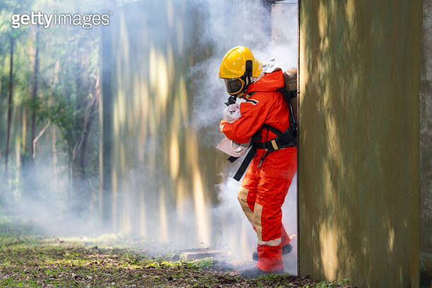 Firefighter in Action, Protecting People from Fire and Smoke. Fearless ...