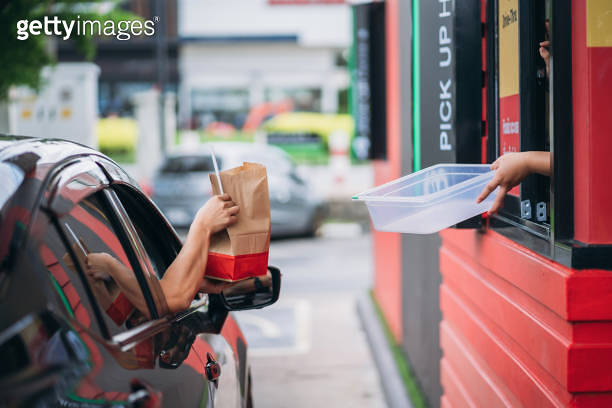 Young Man receiving coffee at drive thru counter., Drive thru and take ...