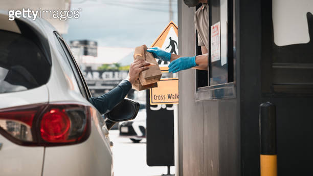 Young Man receiving coffee at drive thru counter., Drive thru and take ...
