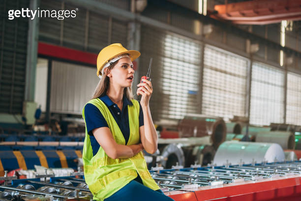 Portrait of Industrial worker using walkie-talkie for check up machine ...