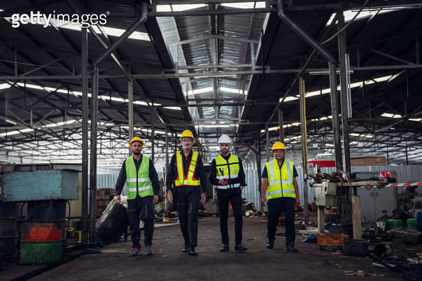 Portrait of Group of Team Mechanical Engineers at Factory Machines ...