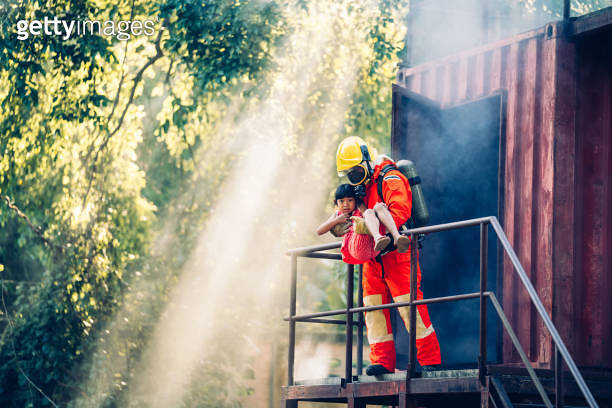 Firefighter in Action, Protecting People from Fire and Smoke. Fearless ...
