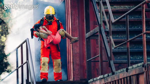 Firefighter in Action, Protecting People from Fire and Smoke. Fearless ...