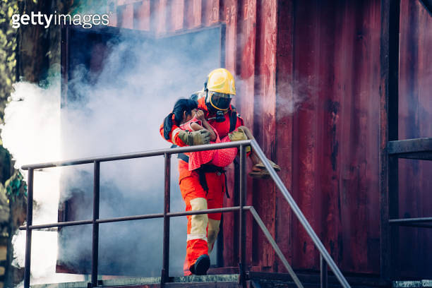 Firefighter in Action, Protecting People from Fire and Smoke. Fearless ...