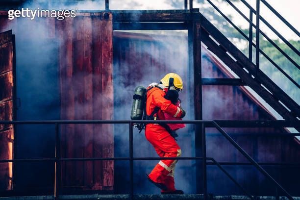 Firefighter in Action, Protecting People from Fire and Smoke. Fearless ...