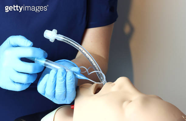 Inflating the endotracheal tube cuff with a syringe with air. Health ...