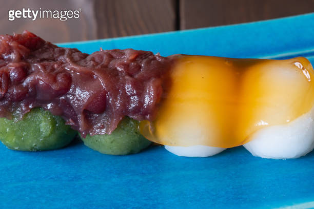 Japanese dumplings topped with red bean paste and mitarashi sauce ...