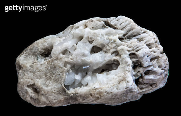 Magnified close up of a hollowed rock with large clear quartz crystals ...