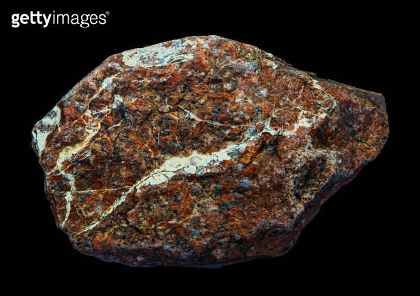 Magnified close up of rust and white colored metamorphic rock with blue ...