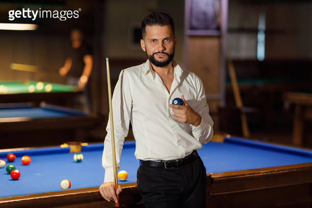 Billiard player at billard table or snooker american billiards pool ...