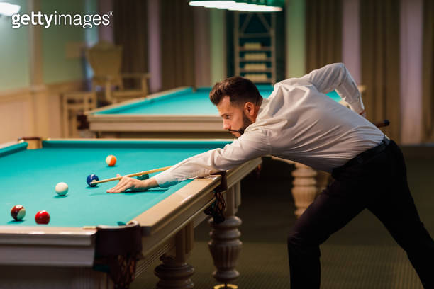 Billiard player at billard table or snooker american billiards pool ...