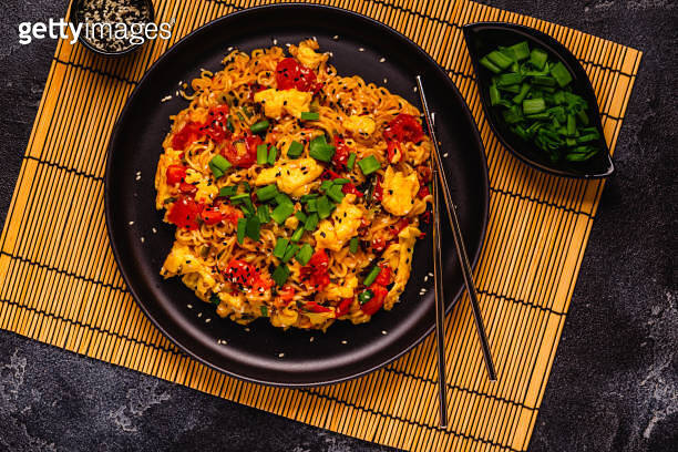 Korean style instant noodle, Shin Ramyeon with tomatoes and scrambled ...