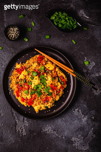 Korean style instant noodle, Shin Ramyeon with tomatoes and scrambled ...