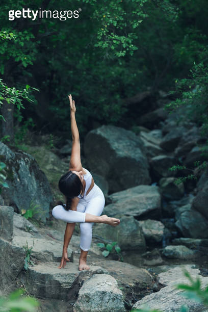 the guy performs the balance asana on one leg. meditation in nature ...