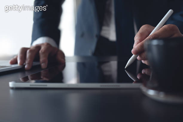 Close up, businessman using stylus pen signing e-document on digital ...