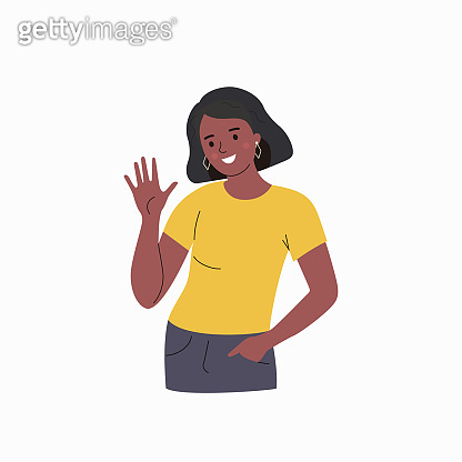 Young woman waives hand in hello gesture while smiling cheerfully and ...