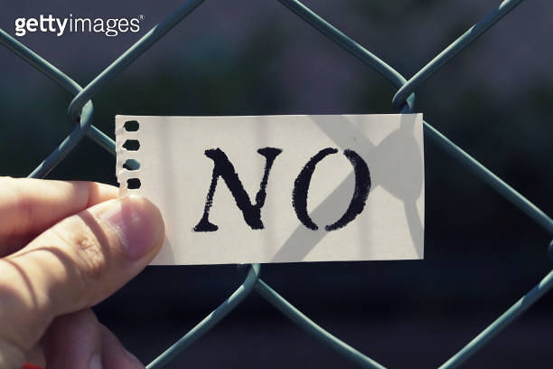Person holding a piece of paper that says NO 이미지 (1478890391) - 게티이미지뱅크