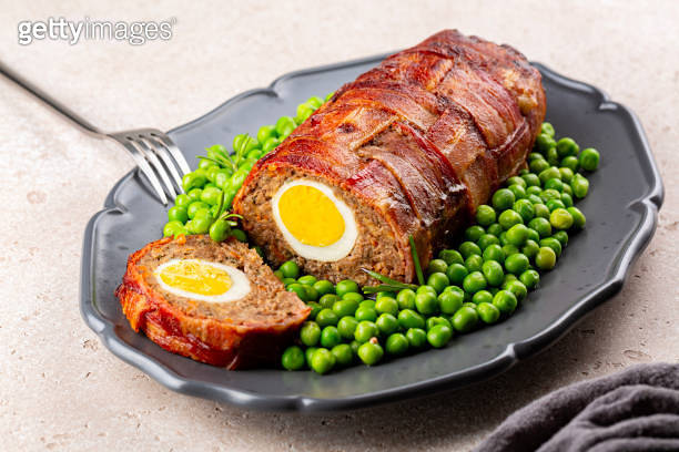 Slice of baked meatloaf made of ground meat, onion, carrot, stuffed ...