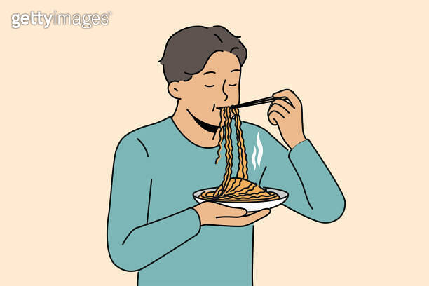 Asian man eats ramen with chinese sticks, enjoying taste of traditional ...
