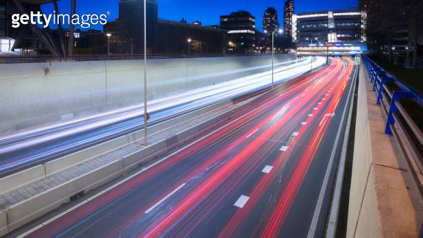 High-speed traffic in the city. Expressway. Night cityscape. Blurred ...