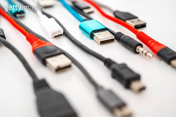 USB and smartphone cables and connectors of various types and colours ...