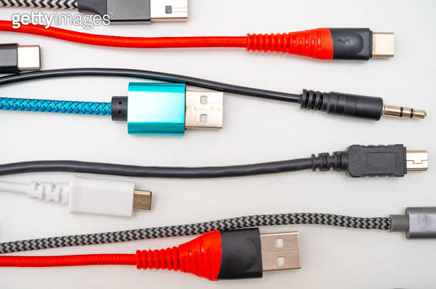 USB and smartphone cables and connectors of various types and colours ...