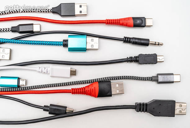 USB and smartphone cables and connectors of various types and colours ...