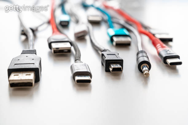 USB and smartphone cables and connectors of various types and colours ...