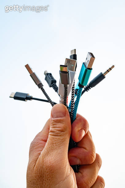 USB and smartphone cables and connectors of various types and colours ...