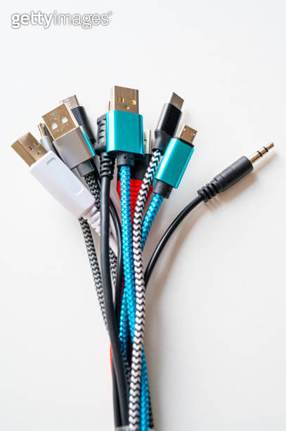 USB and smartphone cables and connectors of various types and colours ...
