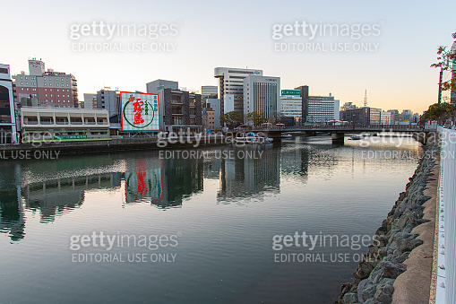 A view of Nakasu in the evening. Naka River (Naka-gawa) and buildings ...