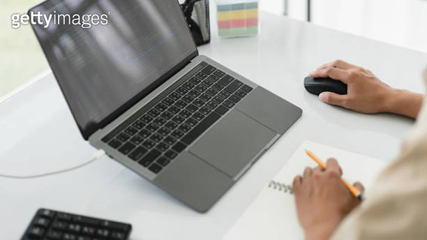 Developer programmer use mouse and checking code on laptop while programming to developing ...