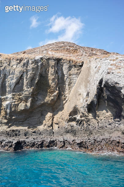 Rocky cliff seen from the water, Galapagos Islands, Ecuador ...