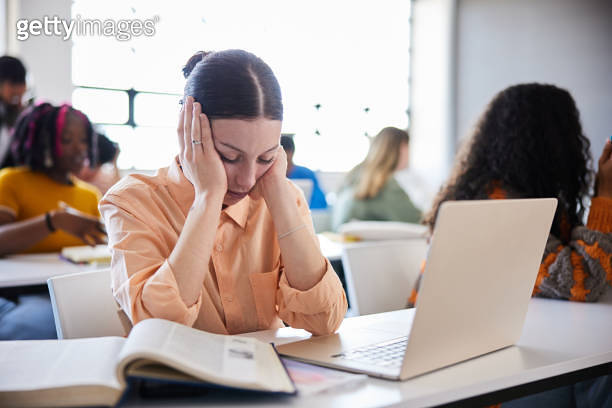 Female college student looking confused during a class at school 이미지 ...