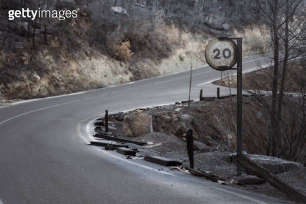 Burnt road sign after wildfire in the forest - Bush fire damage ...