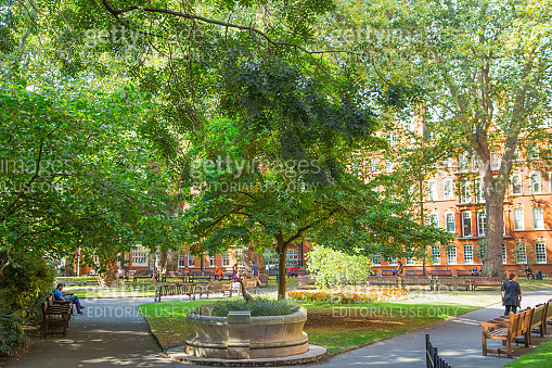 Local park in Mayfair with beautiful periodic buildings around. People ...