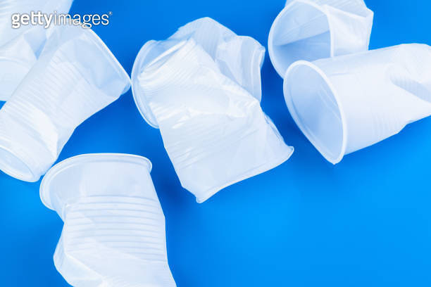 Disposable colored plastic cups garbage. Garbage and pollution concept ...