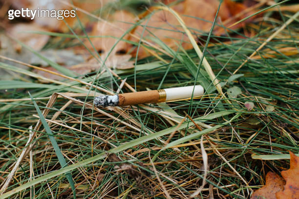 Environmental problem and danger, close-up of an abandoned smoking ...