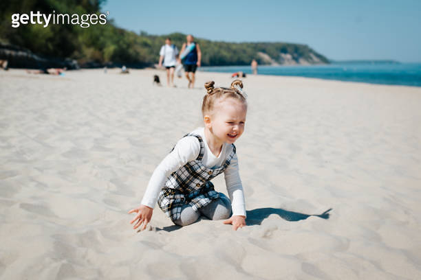 Little girl fell and hit on the beach, pain. Caucasian child incident ...